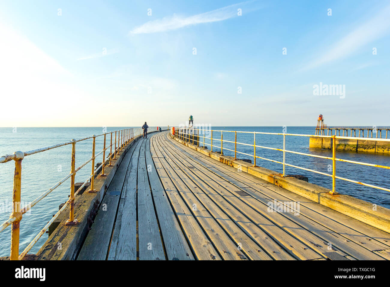 WHITBY, ENGLAND Tourists visiting Whitby Pier and lighthouse. 12/05 ...