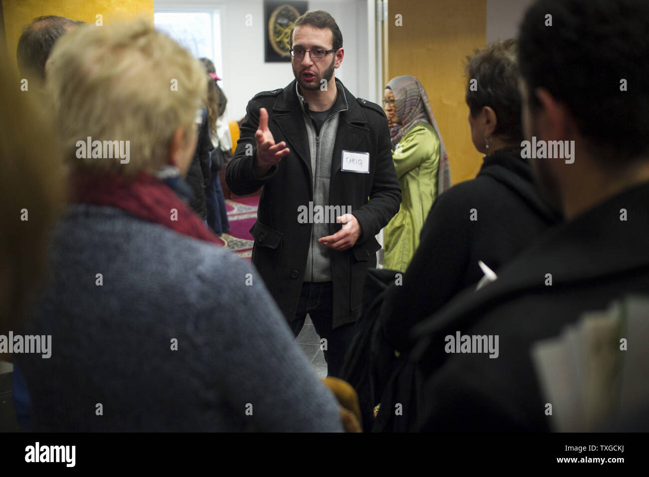 Volunteer Tareq Khreim (C) gives a tour of the Worcester Islamic Center ...