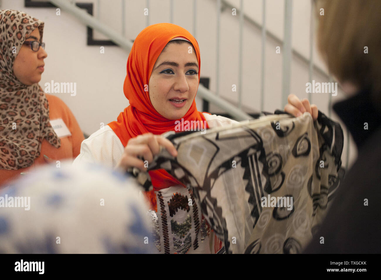 Volunteer Asma Kayal (C) demonstrates how a Hijab is worn during 'Meet ...