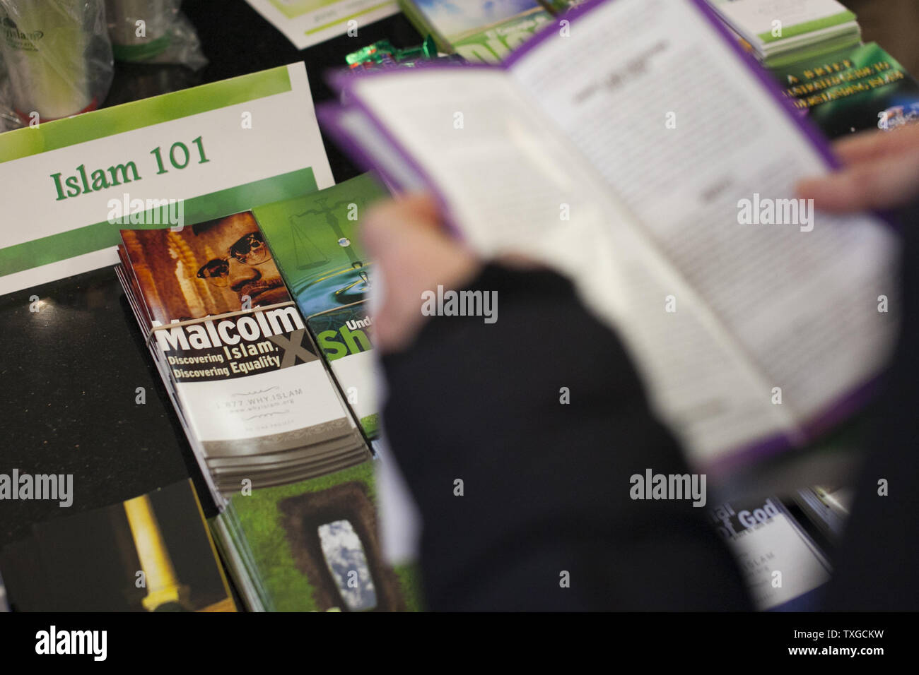 A person reads a pamphlet about Islam during 'Meet-a-Muslim' day held ...