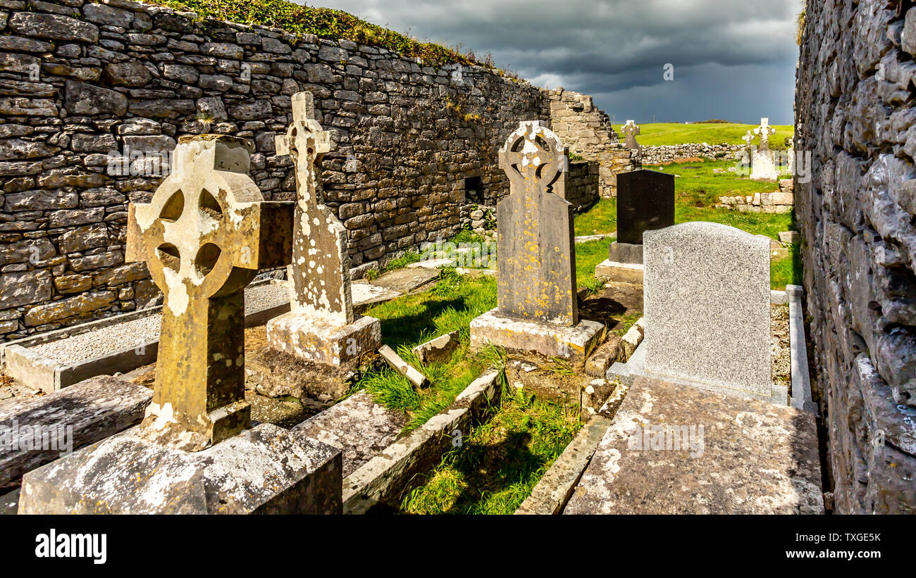 View of the ruined tombs in the graveyard and walls of the medieval ...
