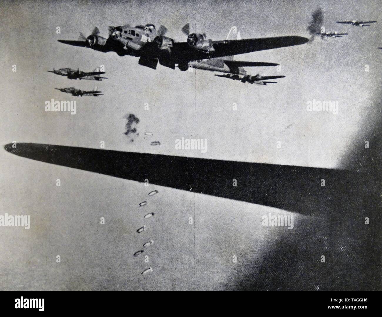 Photograph of Boeing B-17 Flying Fortresses dropping bombs during the ...