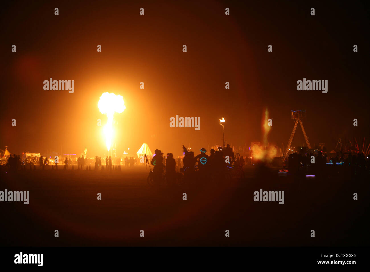 A fireball illuminates the Playa at Burning Man in Black Rock City ...