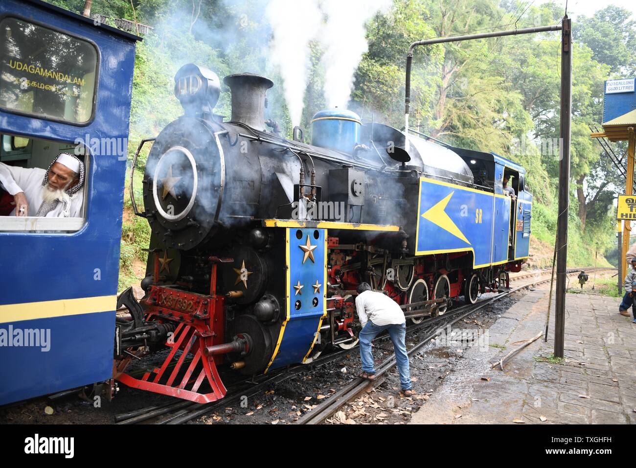 Nilgiri mountain railway. X class steam locomotive taking on water at ...