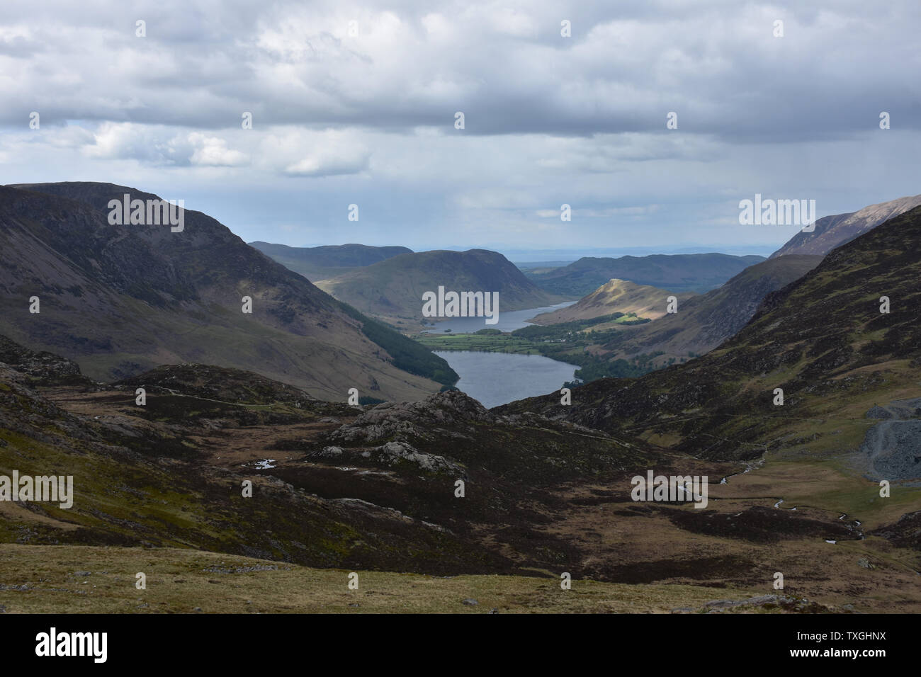 Blackbeck Tarn surrounded by crags and fells in England Stock Photo - Alamy