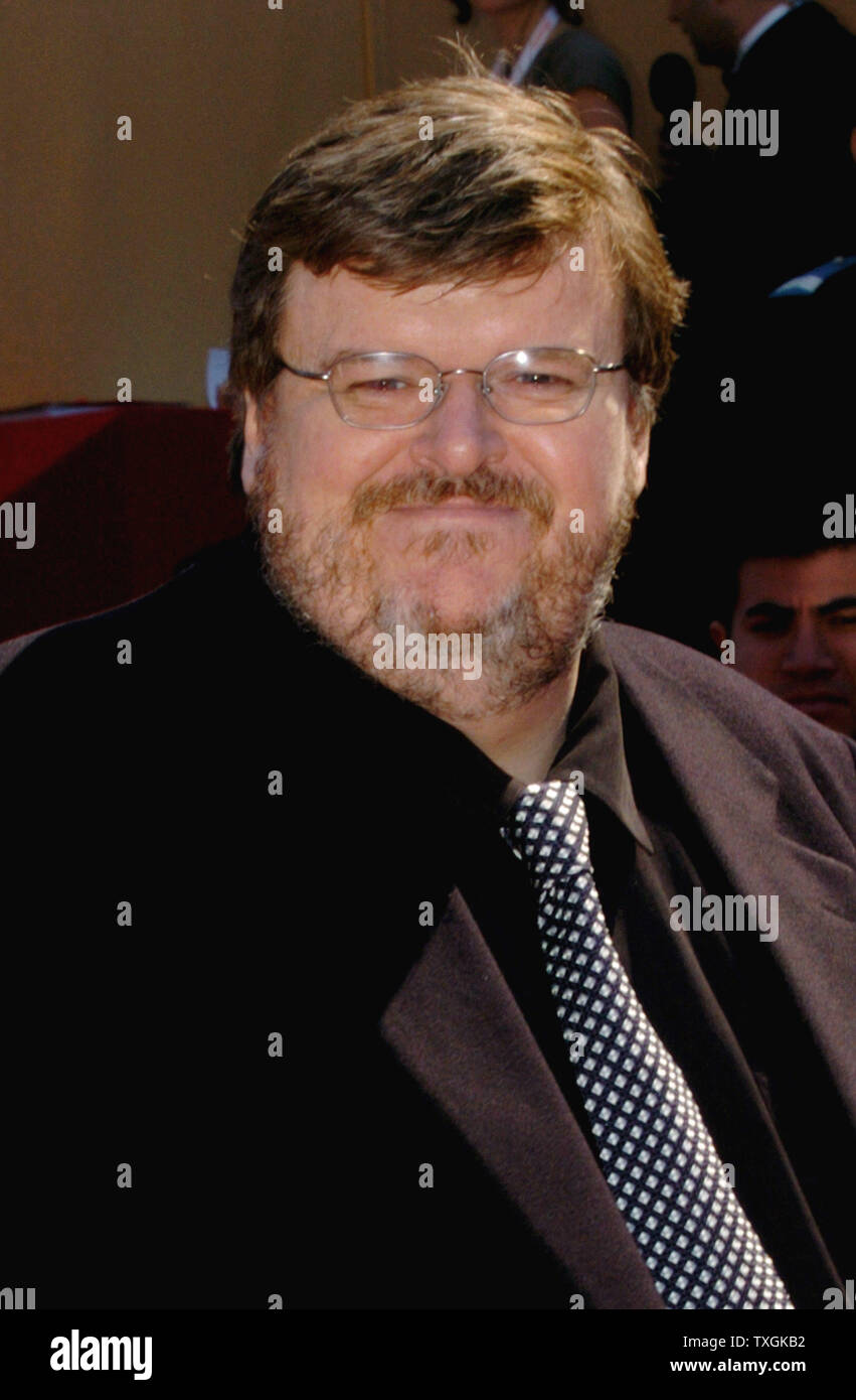 Director Michael Moore poses for photographers on the red carpet before ...