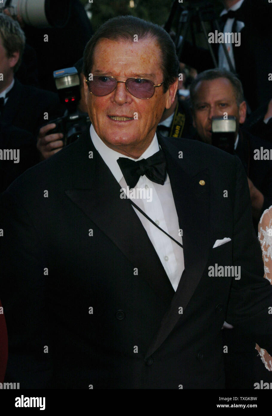 Actor Roger Moore poses for photographers on the red carpet before the ...