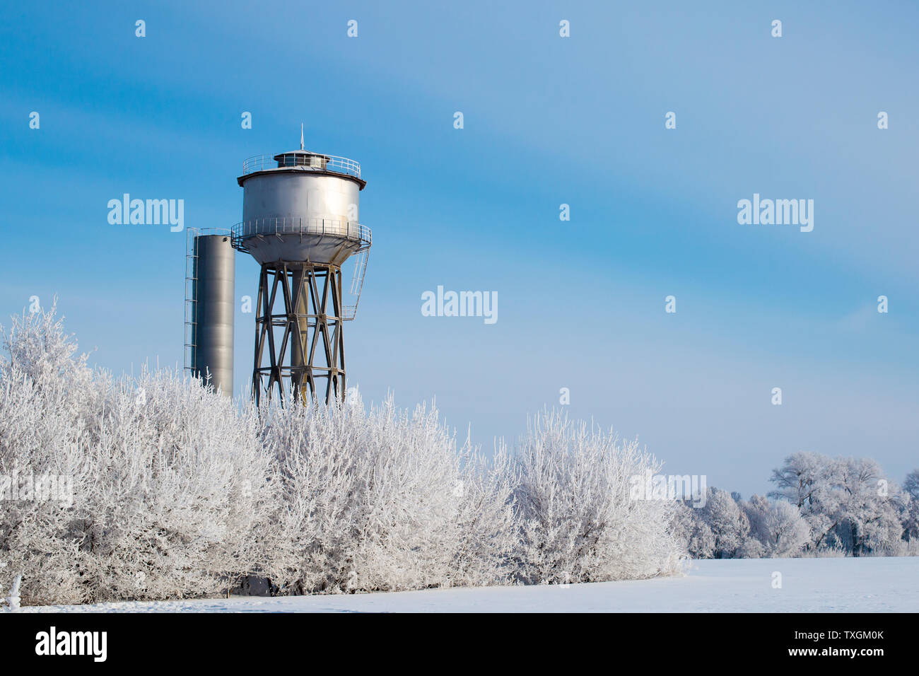 Small town water tower, lit by sunlight Stock Photo - Alamy
