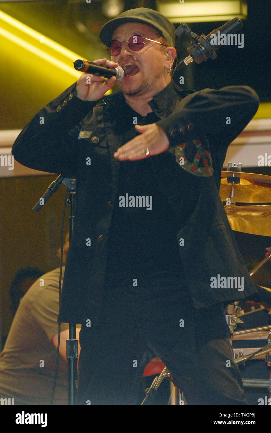 U2 lead singer Bono performs a song on the red-carpeted steps of the ...
