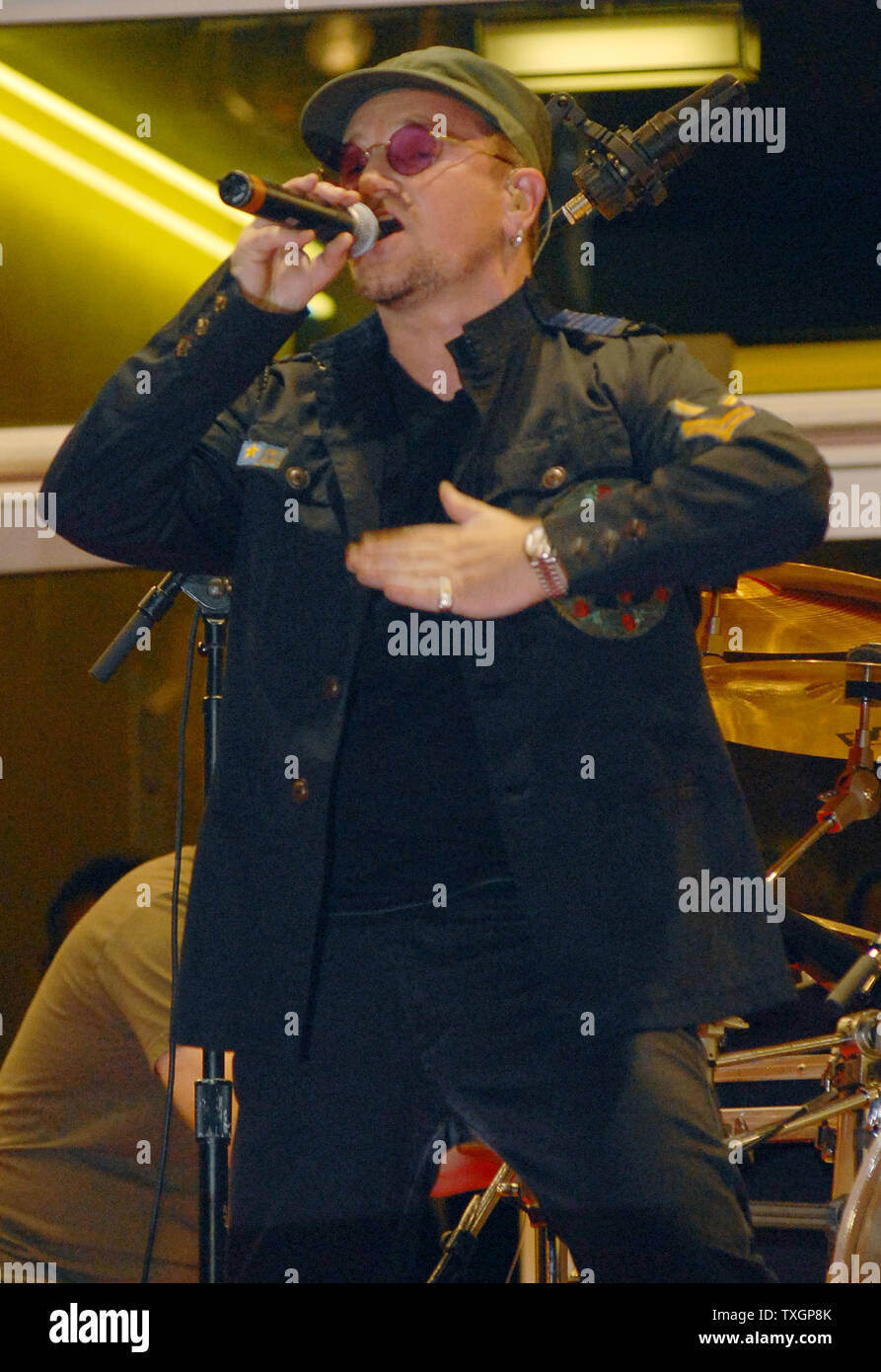 U2 lead singer Bono performs a song on the red-carpeted steps of the ...