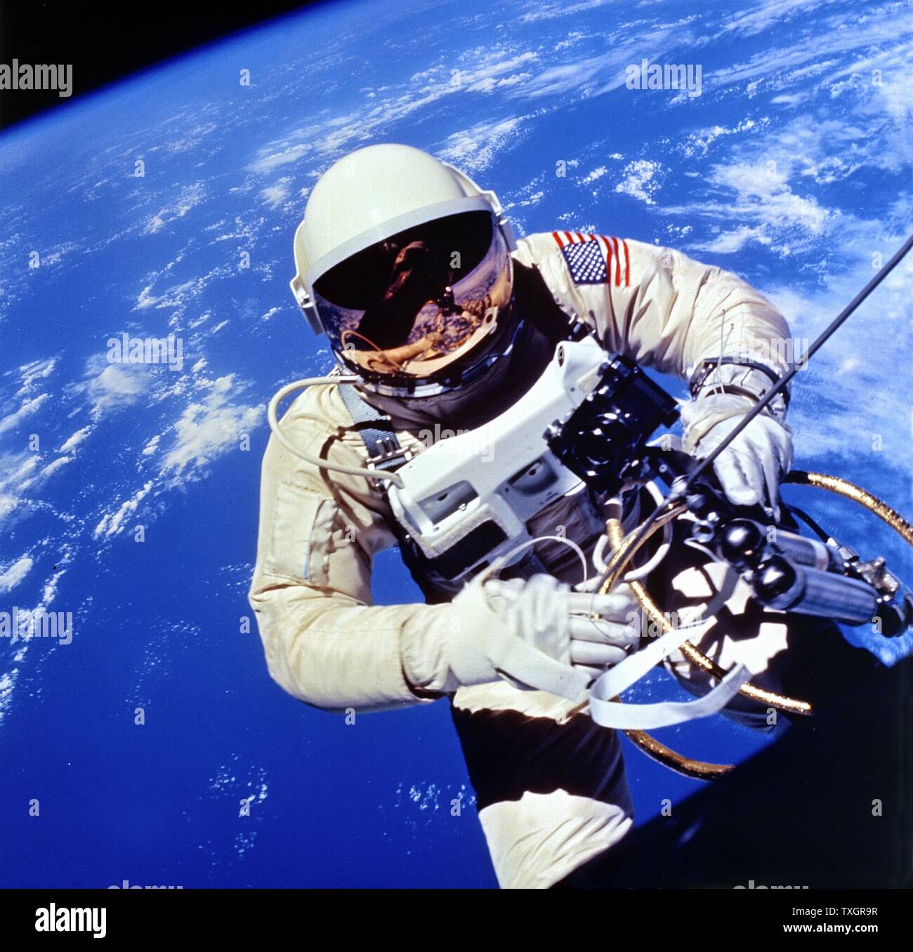 US Astronaut Edward H. White II carrying out external tasks during ...