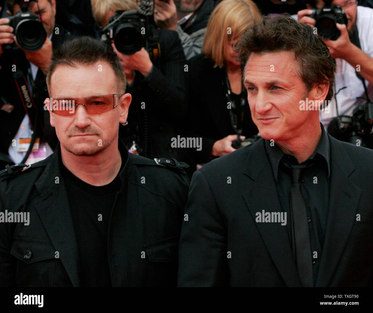 U2 frontman Bono (L) and actor Sean Penn arrive on the red carpet ...