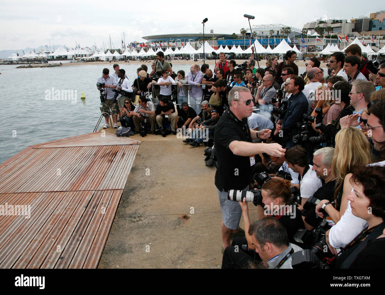 Photographers await the arrival of actor Jude Law and director Jeremy ...