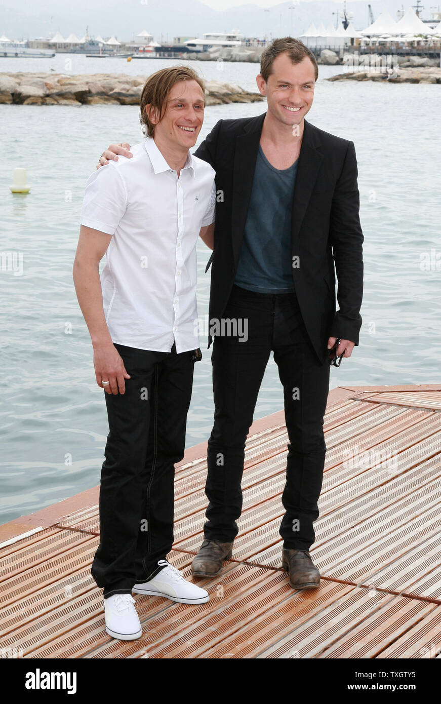 Actor Jude Law (R) and director Jeremy Gilley arrive at a photocall for ...