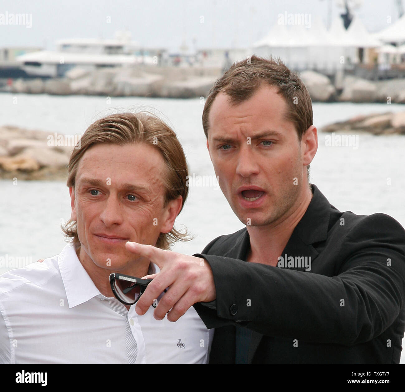 Actor Jude Law (R) and director Jeremy Gilley arrive at a photocall for ...