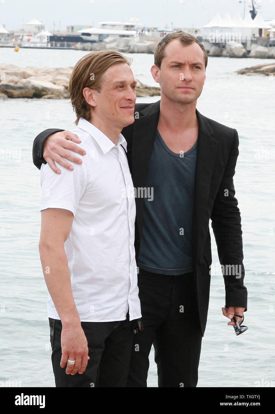 Actor Jude Law (R) and director Jeremy Gilley arrive at a photocall for ...