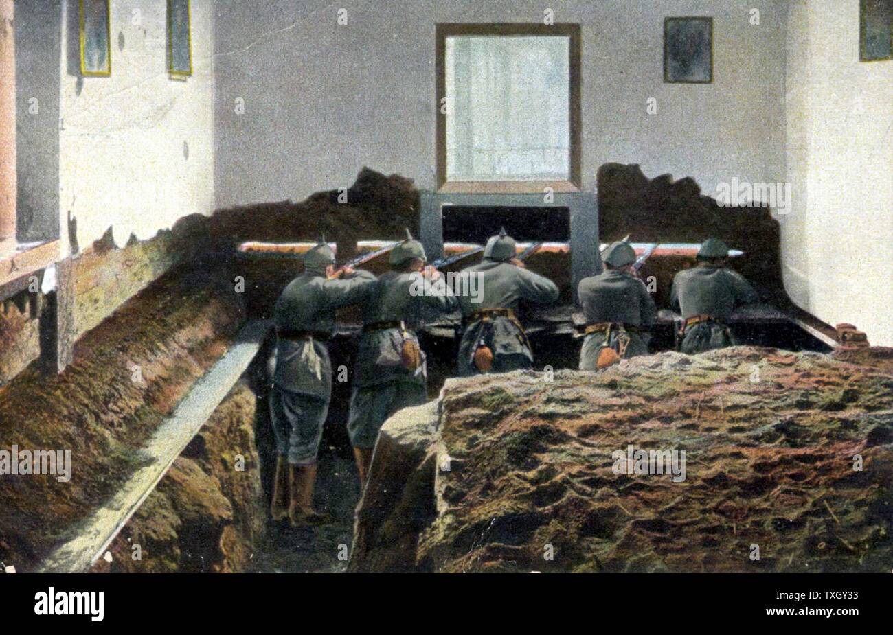 German soldiers in a defensive position in the front room of a house in ...