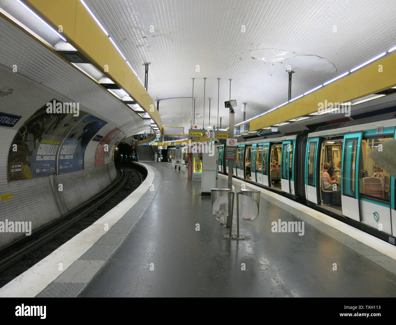 View of a train with its carriage doors open on an underground platform ...