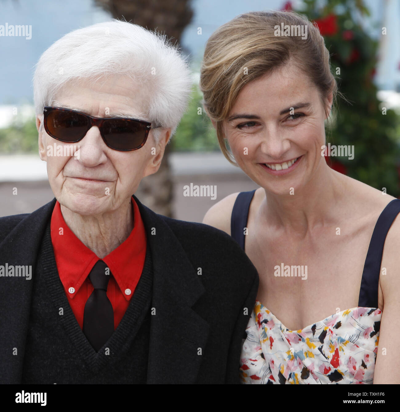 Director Alain Resnais and actress Anne Consigny arrive at a photocall ...