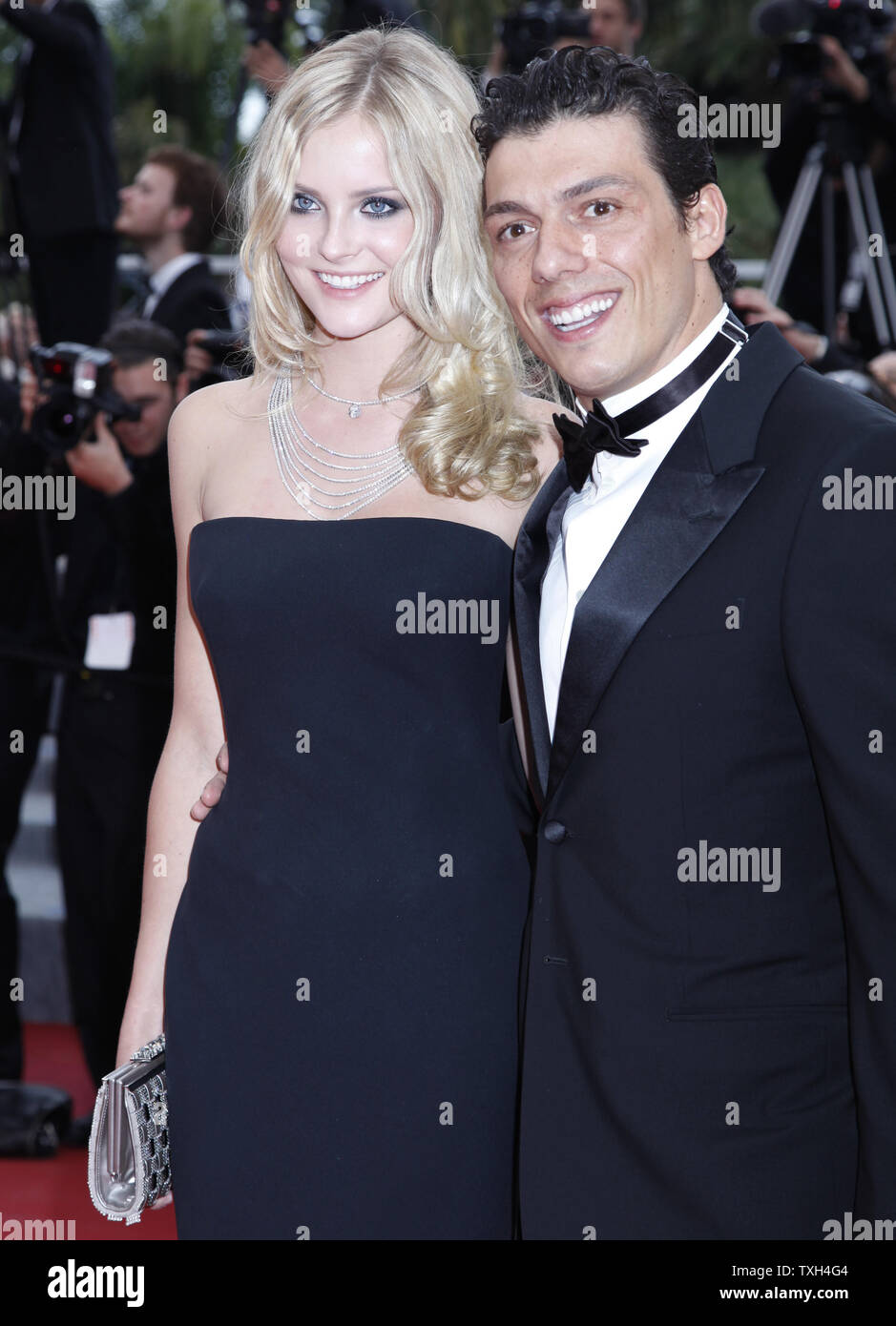 Yann Guyader (R) and guest arrive on the red carpet before the ...