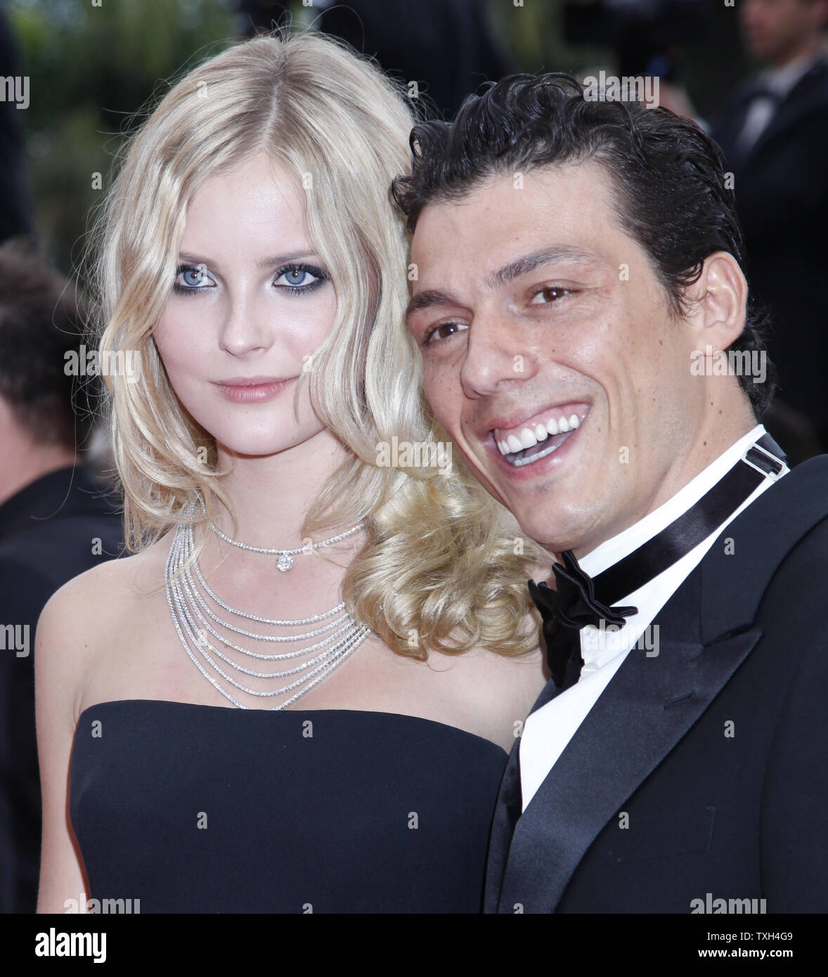 Yann Guyader (R) and guest arrive on the red carpet before the ...