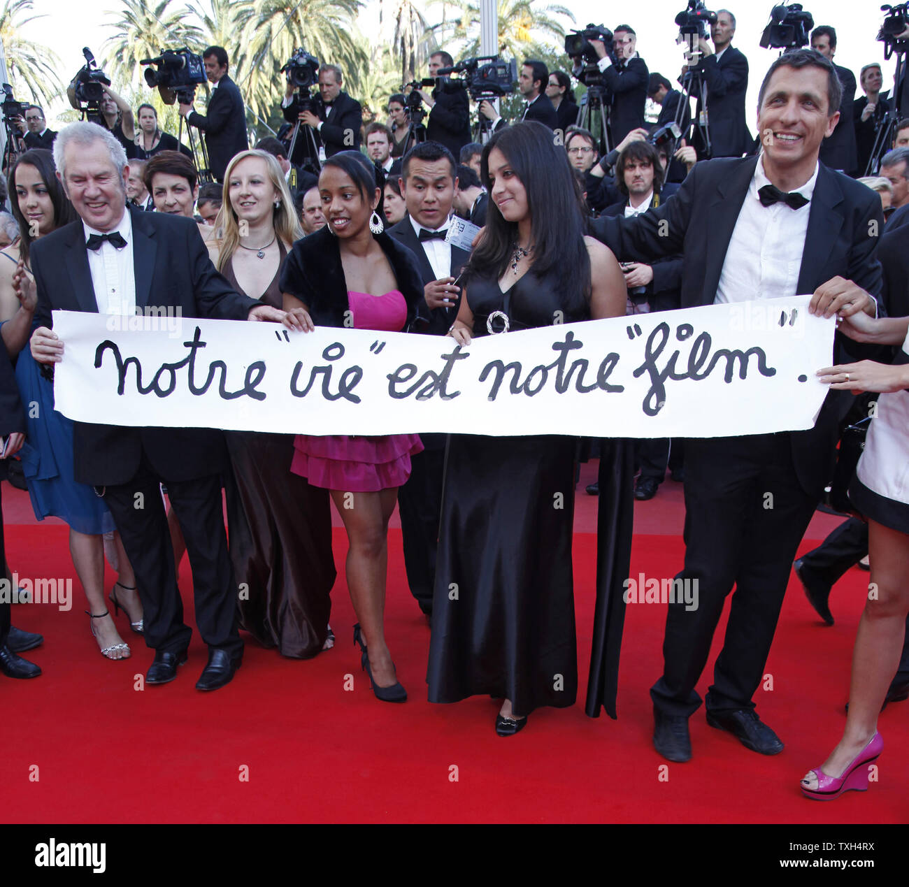 French artist Ben (L) holds a banner reading "Our life is our film" on ...