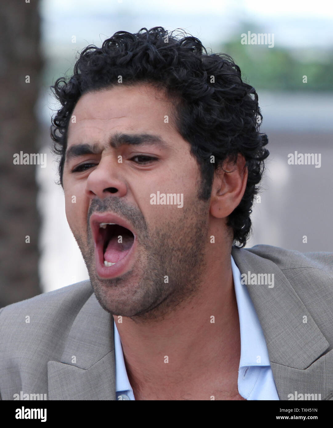 Jamel Debbouze arrives at a photocall for the film "Hors La Loi ...