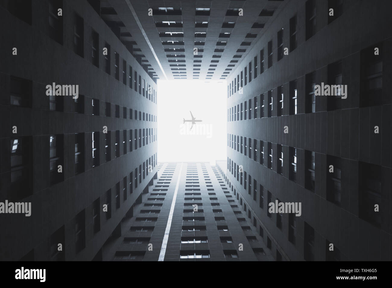 The plane between the high-rise building buildings Stock Photo - Alamy