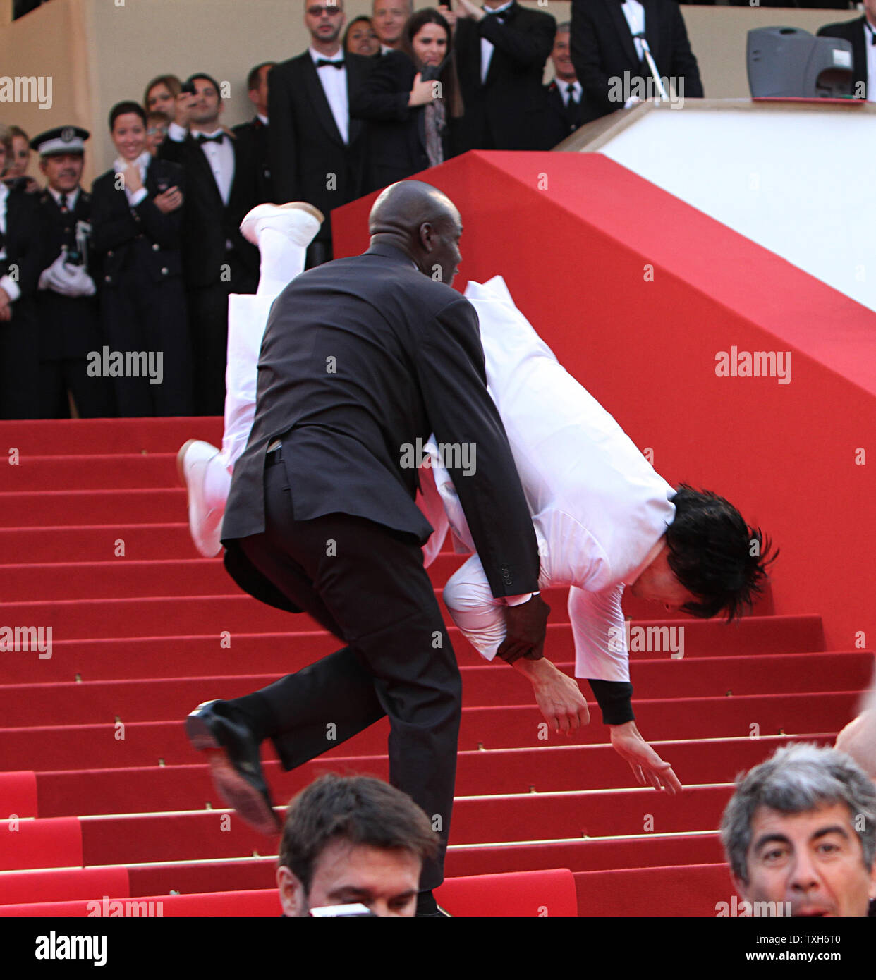 An intruder attempts to get on the red carpet and is stopped by ...