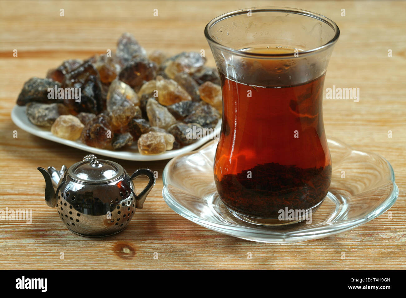 Tea prepared in turkish way, cane sugar and small steel teapot. Five o ...