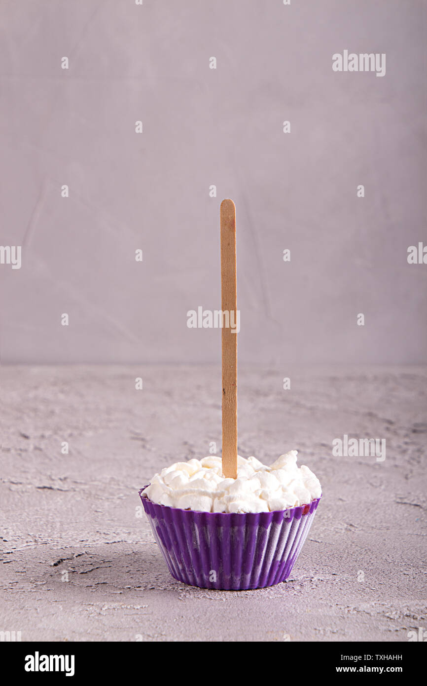 Ice cream popsicle lollies with whipped cream frozen in muffin molds on ...
