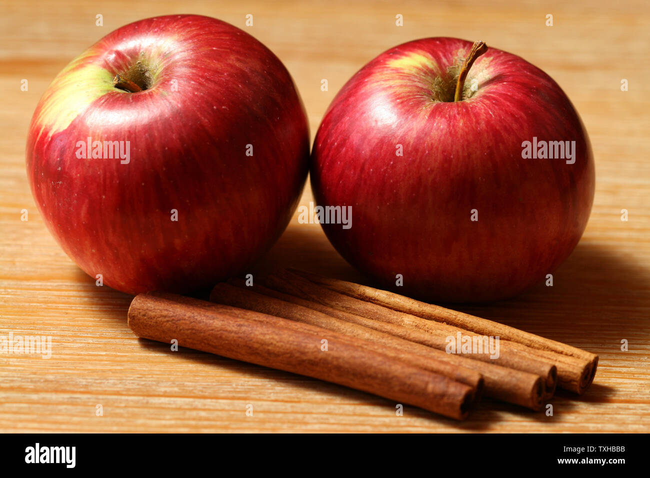 Apples and cinnamon sticks - two juicy fruits on the wooden table Stock ...