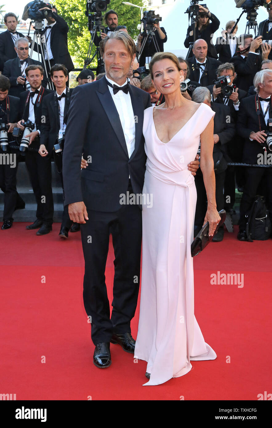 Mads Mikkelsen (L) and Hanne Jacobsen arrive on the red carpet before ...