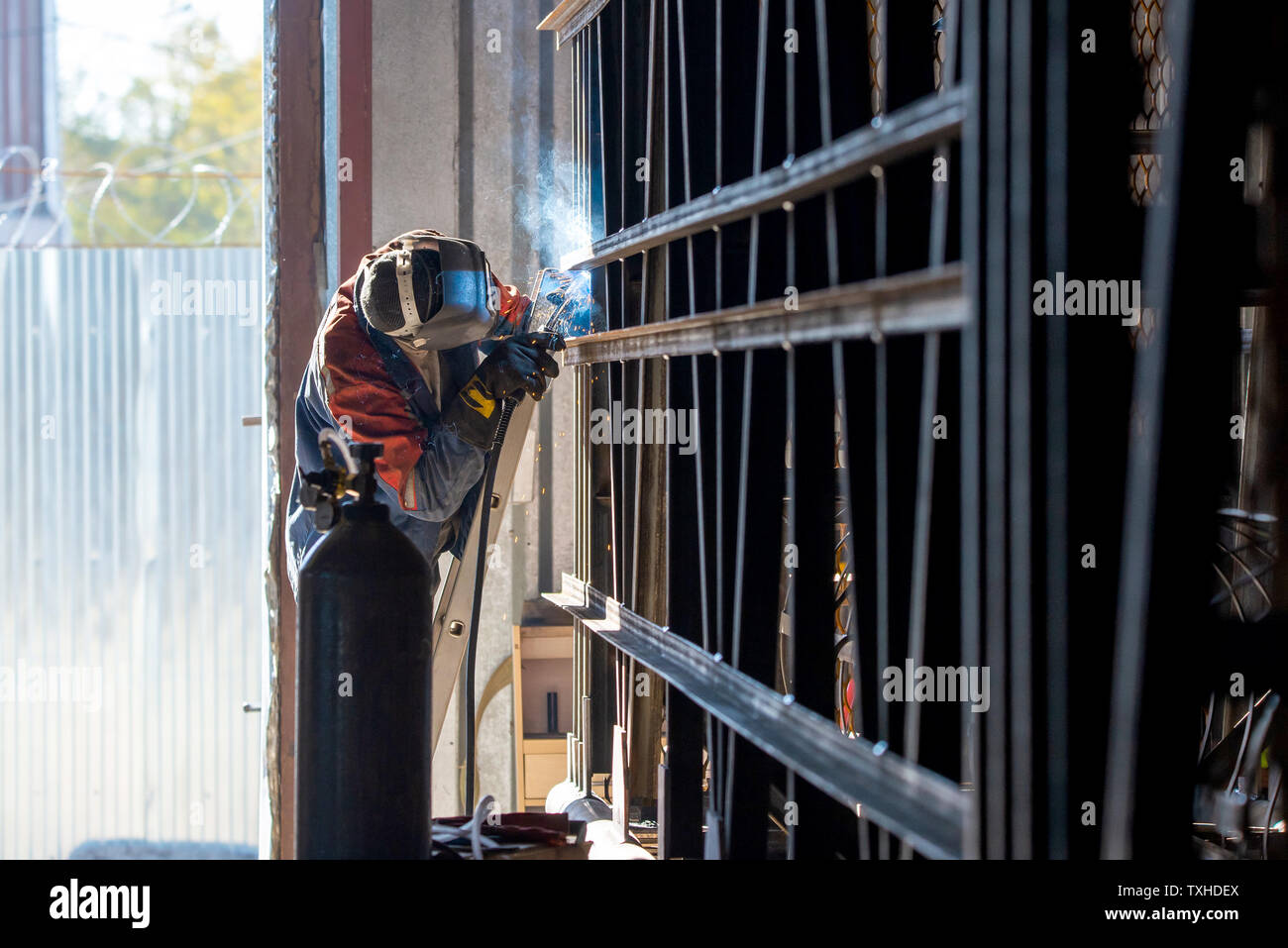 Industrial Worker labourer at the factory arc welding steel structure ...
