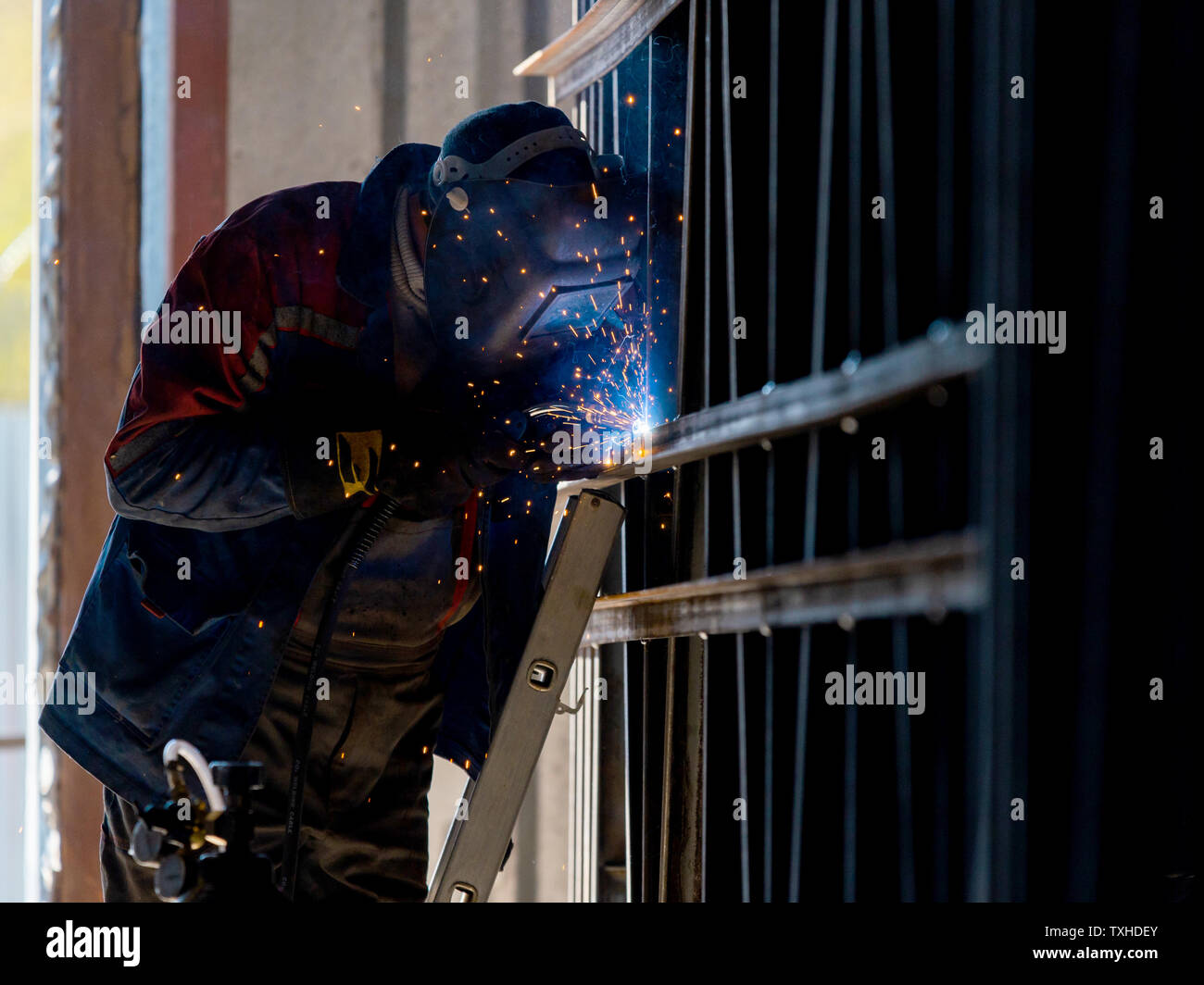 Industrial Worker labourer at the factory arc welding steel structure ...