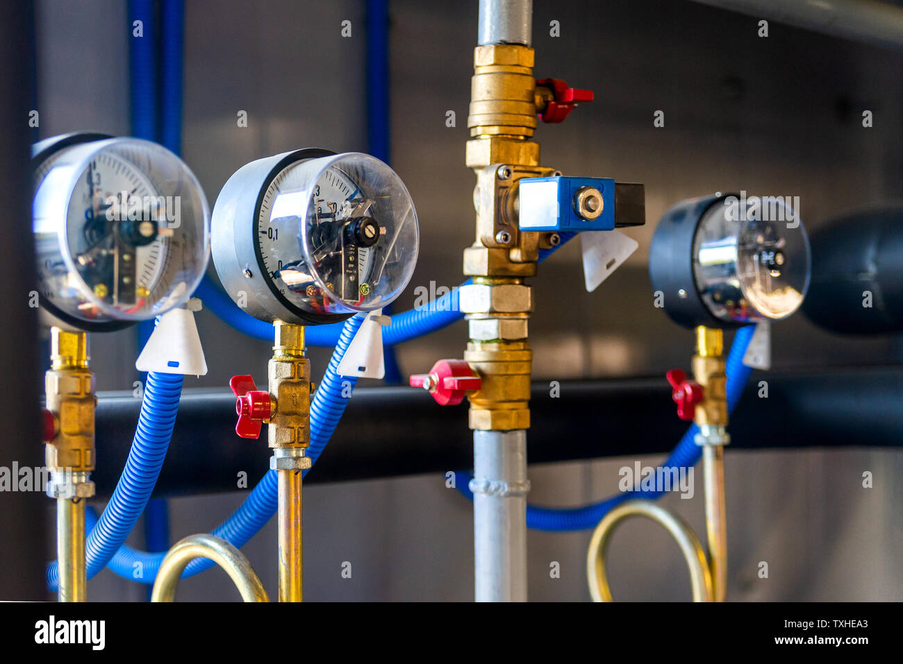 Closeup of manometer, measuring gas pressure. Pipes and valves at ...