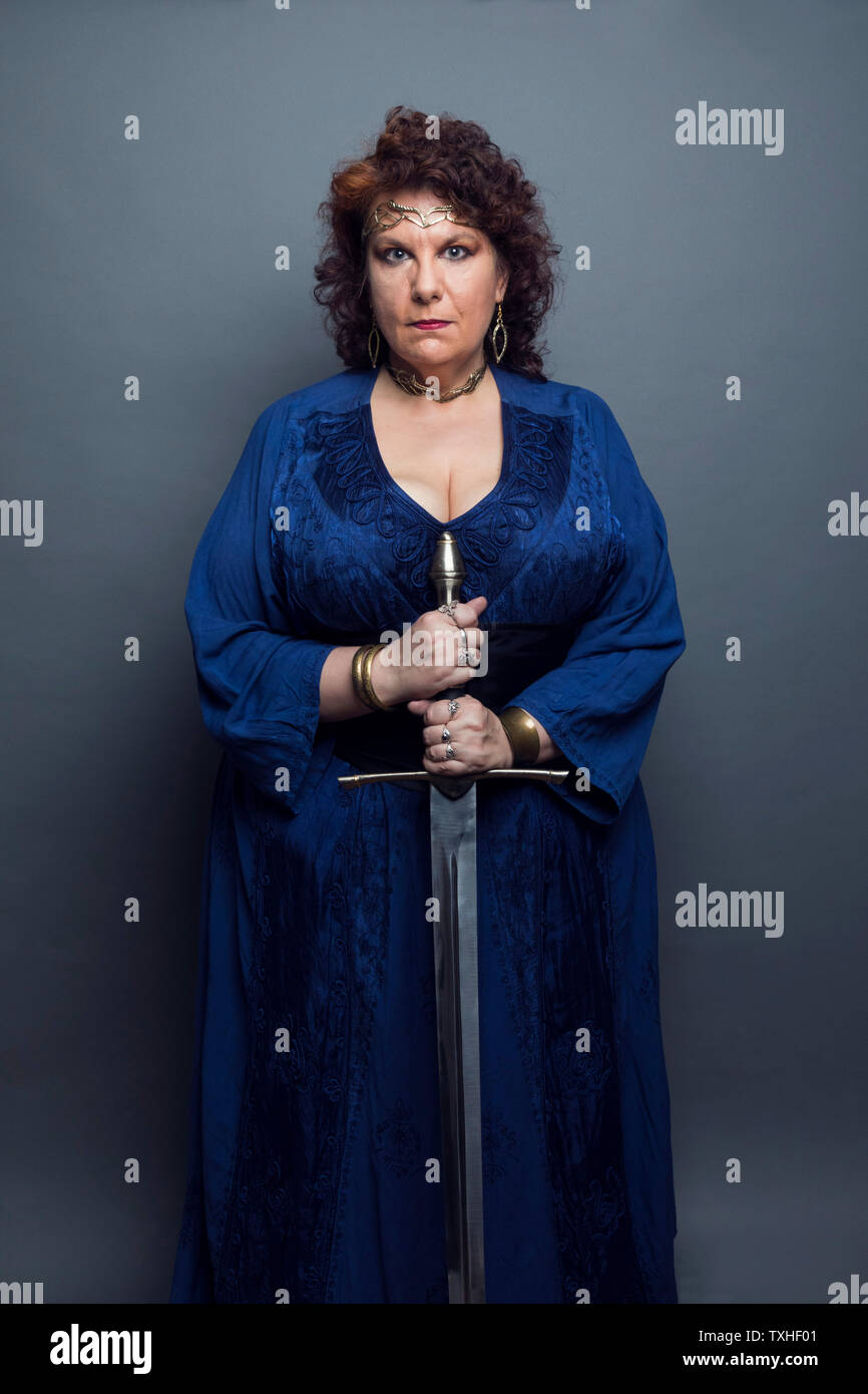 Woman holding a sword Stock Photo - Alamy