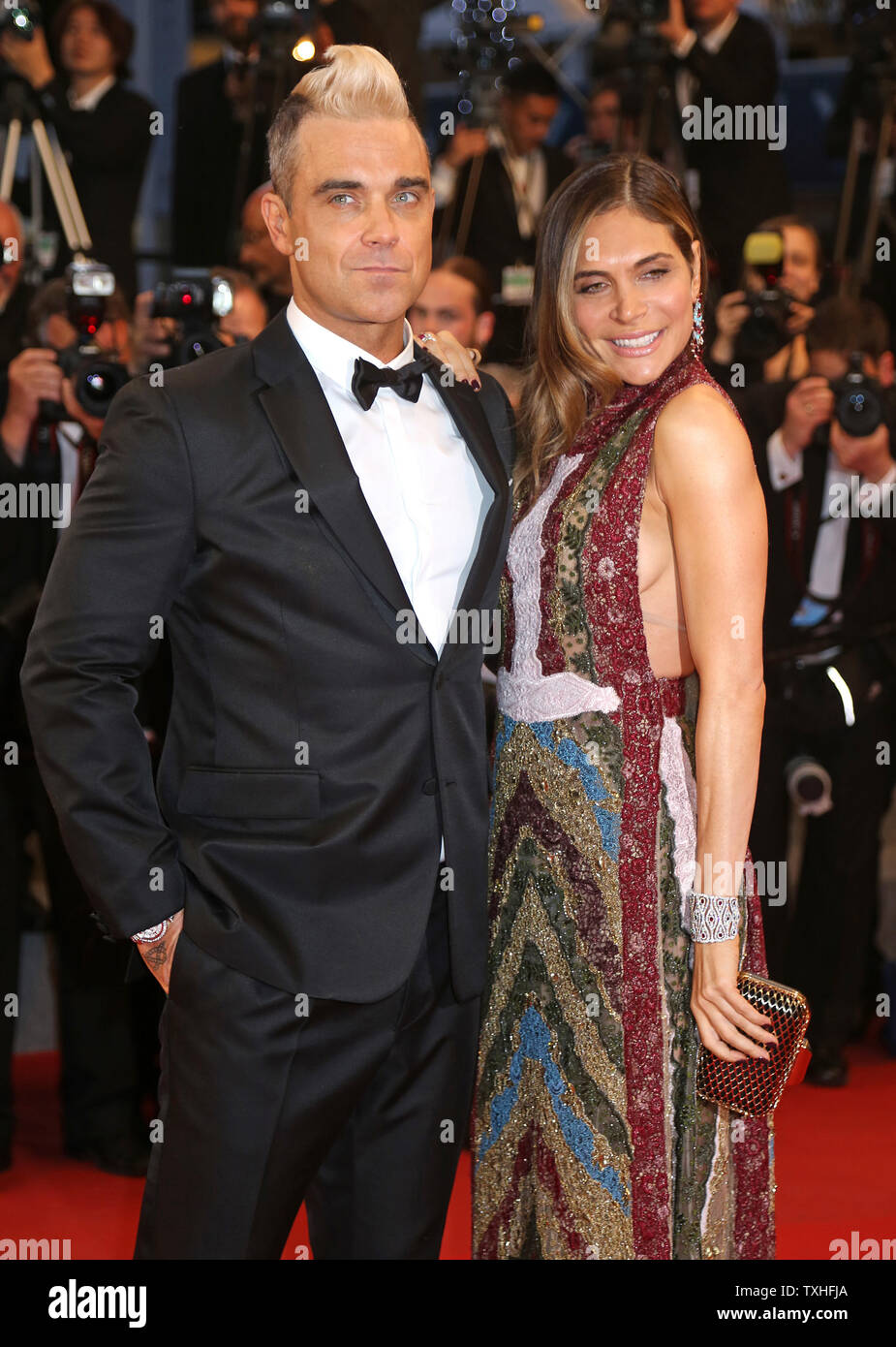 Robbie Williams (L) and Ayda Field arrive on the red carpet before the ...