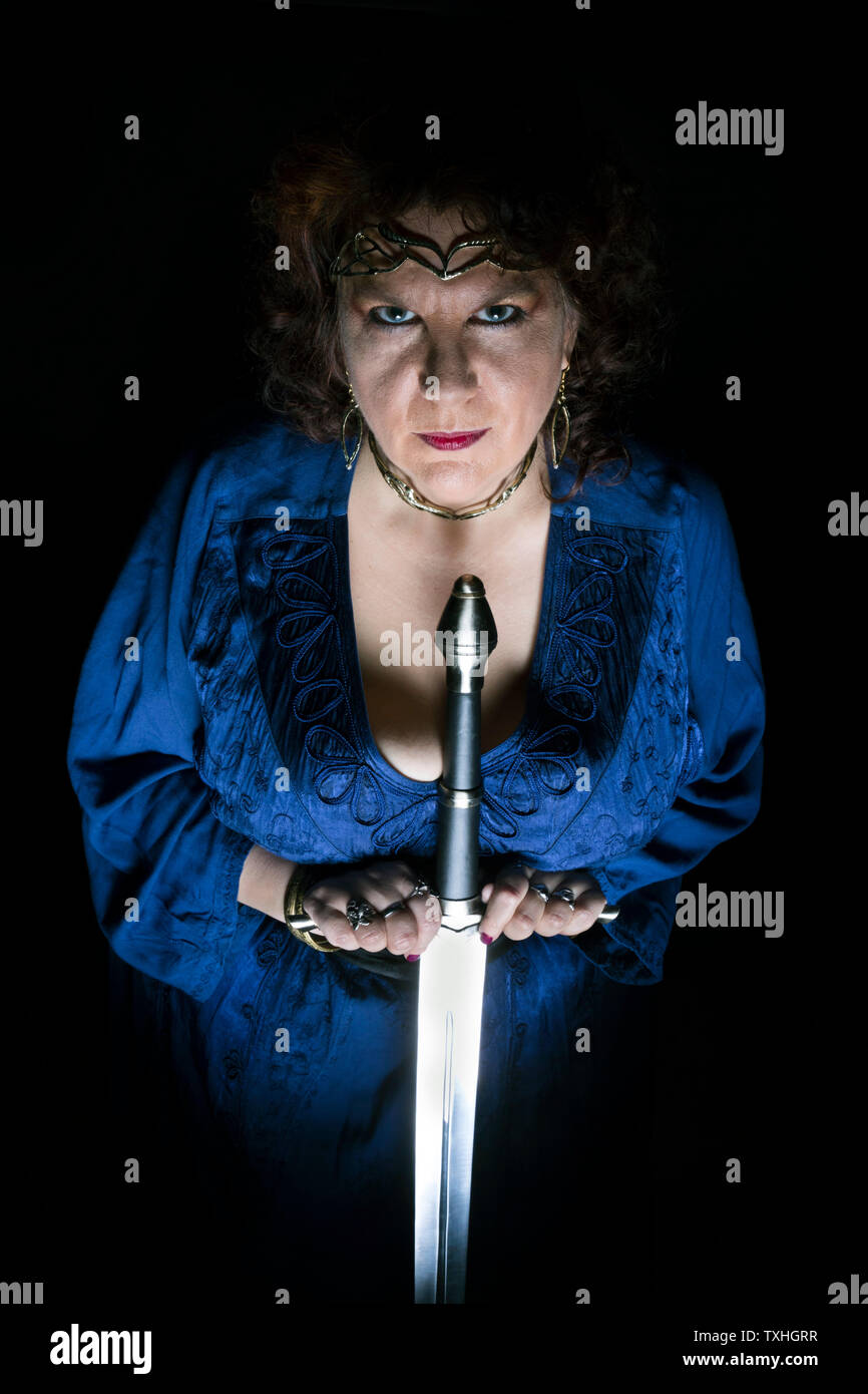 Woman holding a sword Stock Photo - Alamy