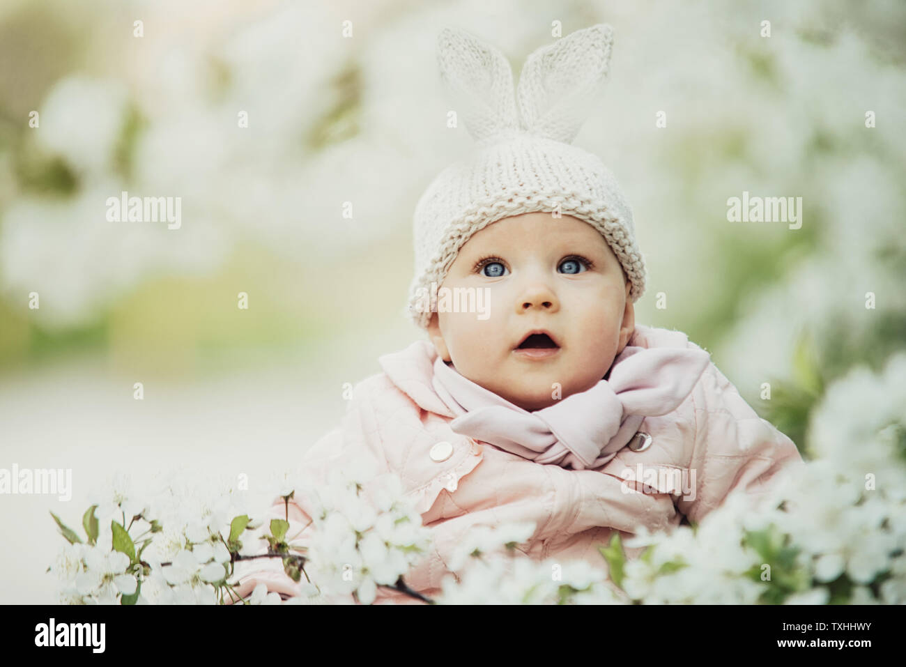 a little girl dressed up as a bunny in flowers, Easter Stock Photo - Alamy