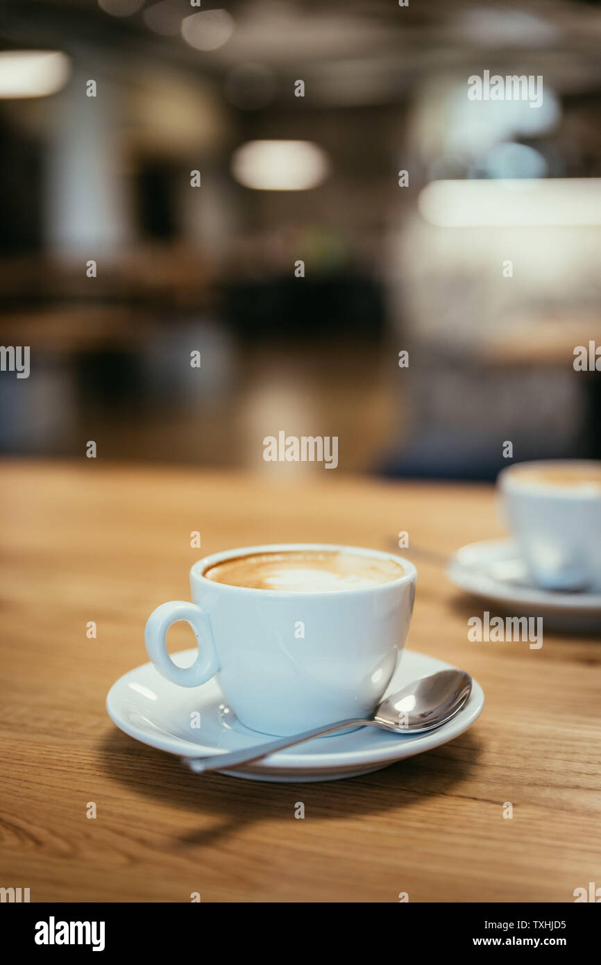Cup of cappuccino, café in the blurry background. Italy Stock Photo - Alamy