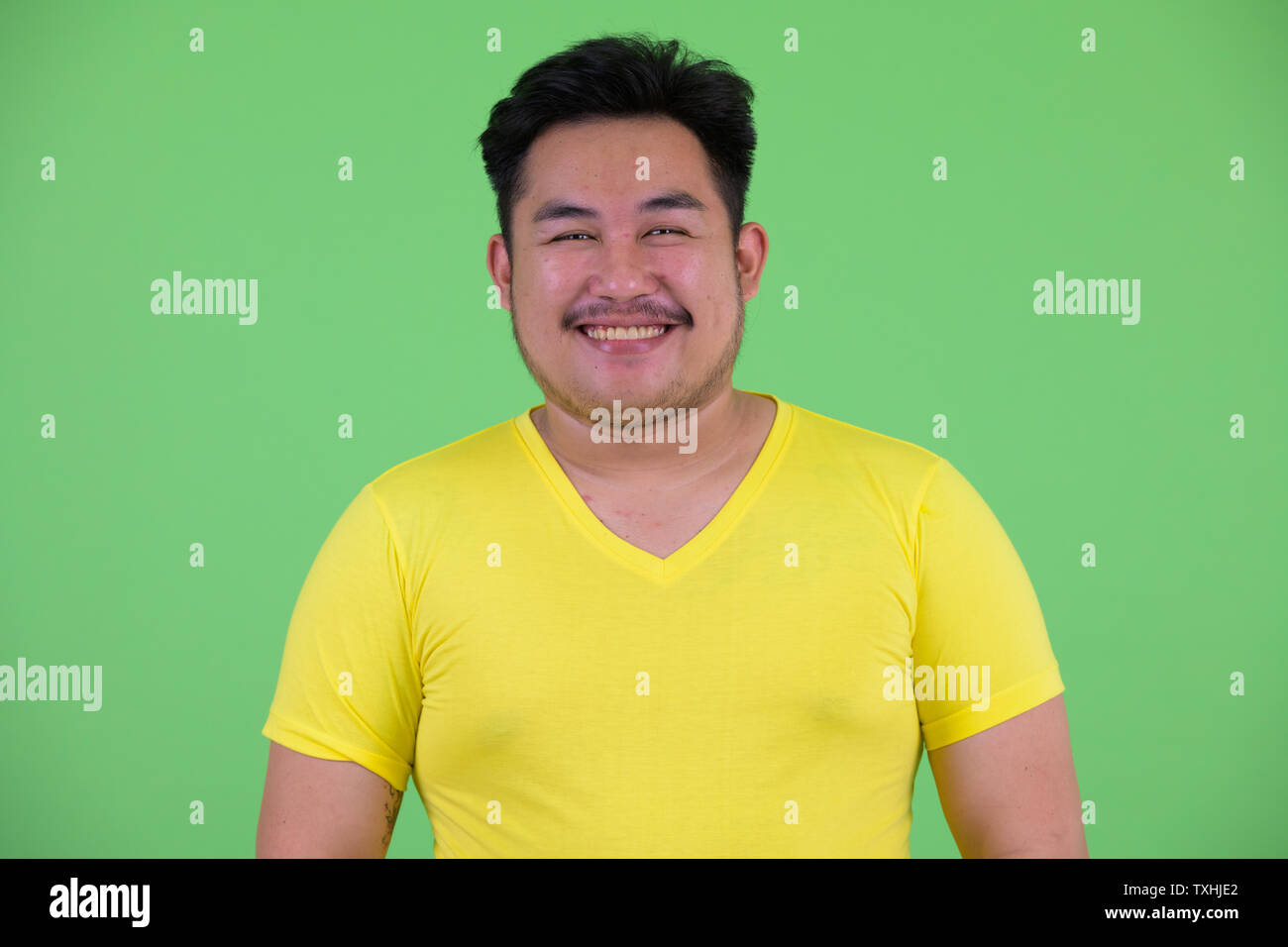 Face of happy young handsome overweight Asian man smiling Stock Photo ...