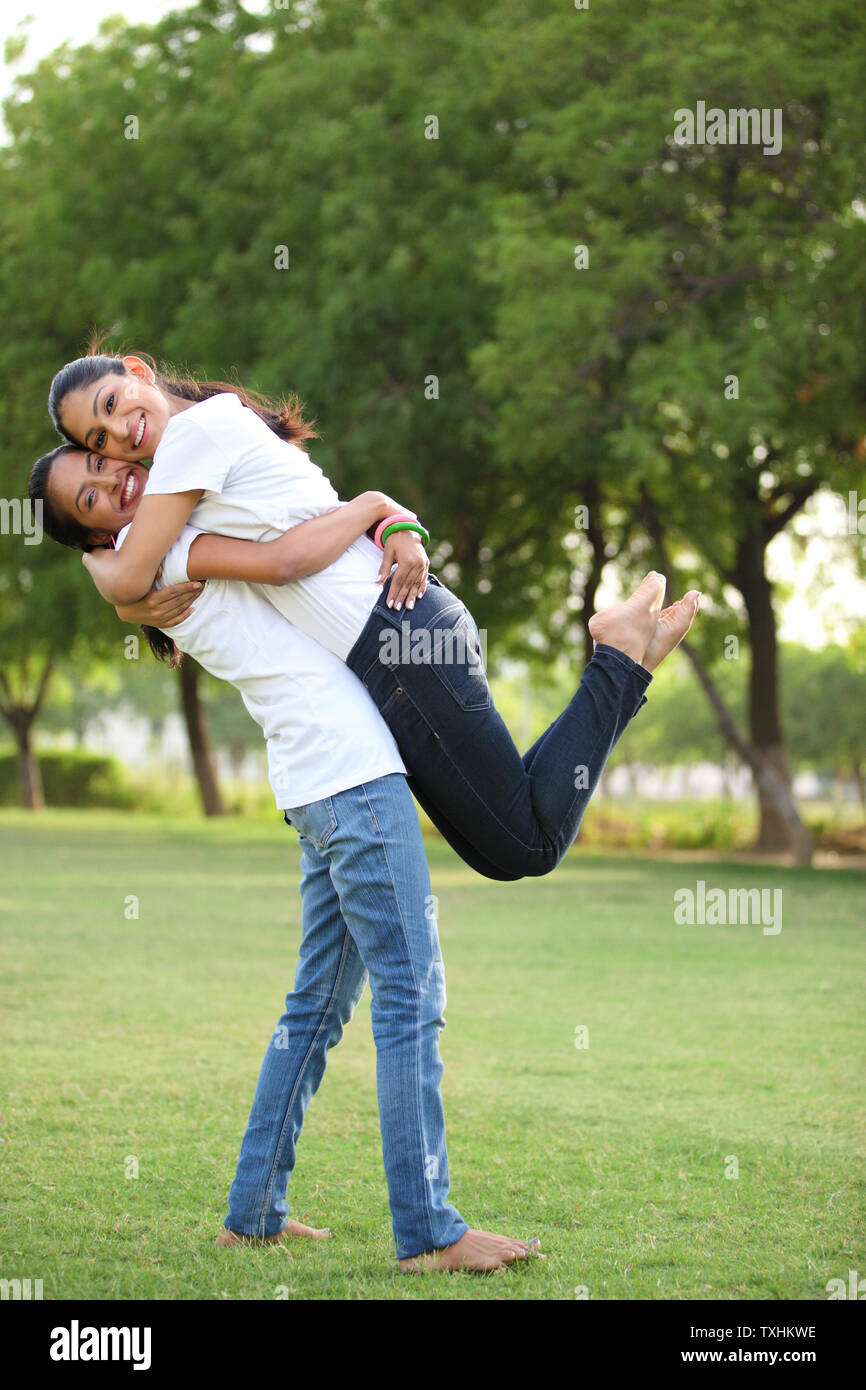 Two friends hugging each other and smiling Stock Photo - Alamy