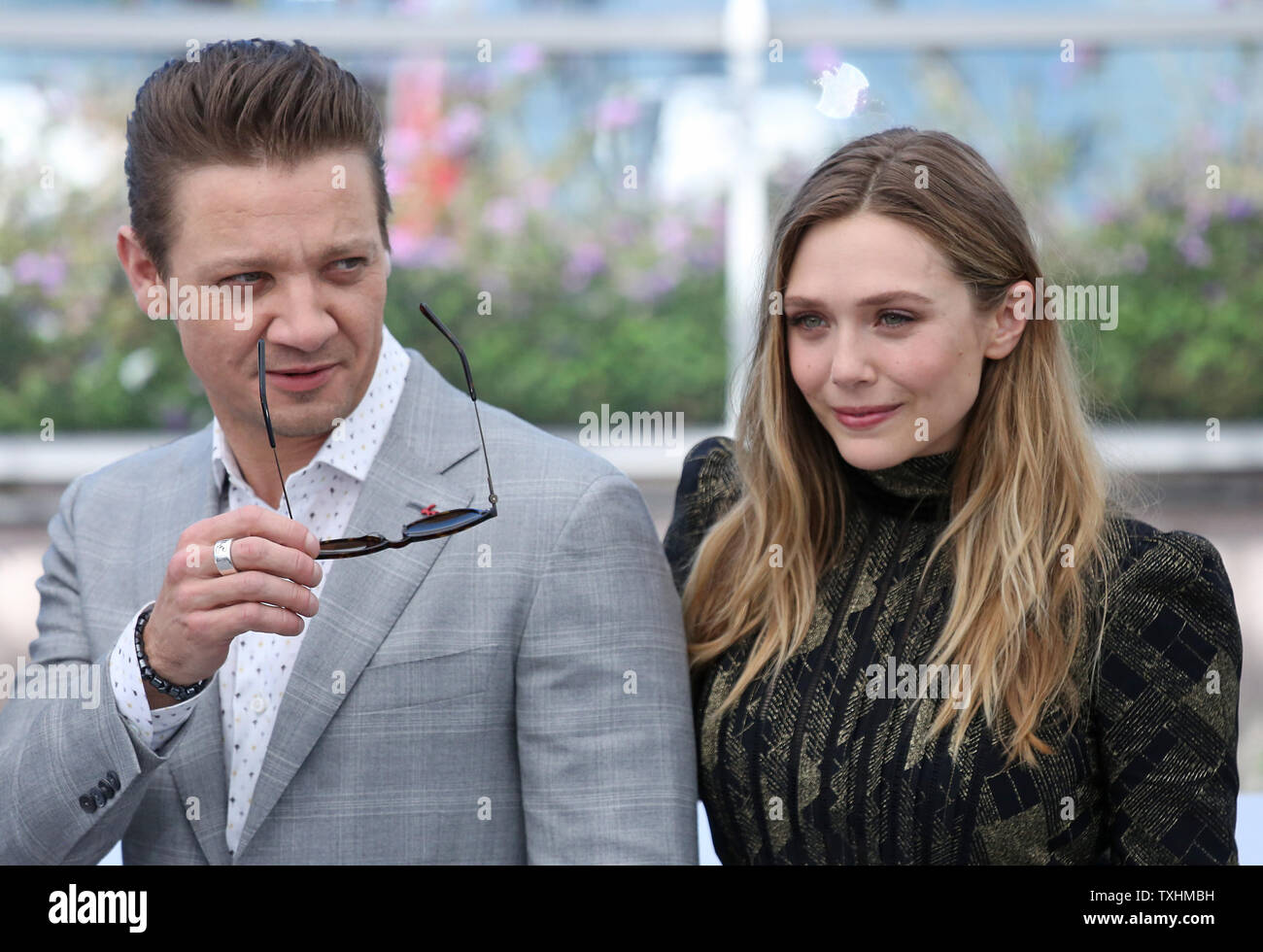 Jeremy Renner (L) and Elizabeth Olsen arrive at a photocall for the ...