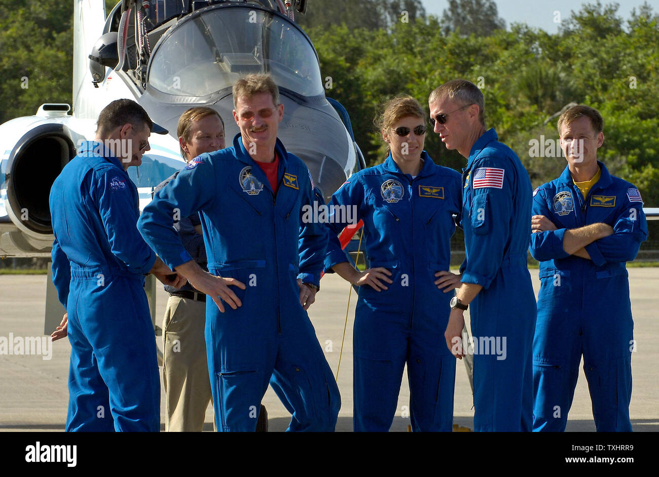 Members of the crew of STS 115 gather around Commander Brent Jett ...
