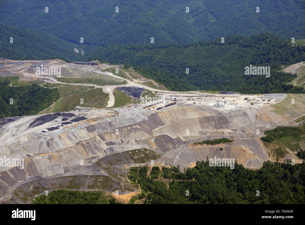 An aerial photo shows a mountaintop removal site and sludge pond in ...