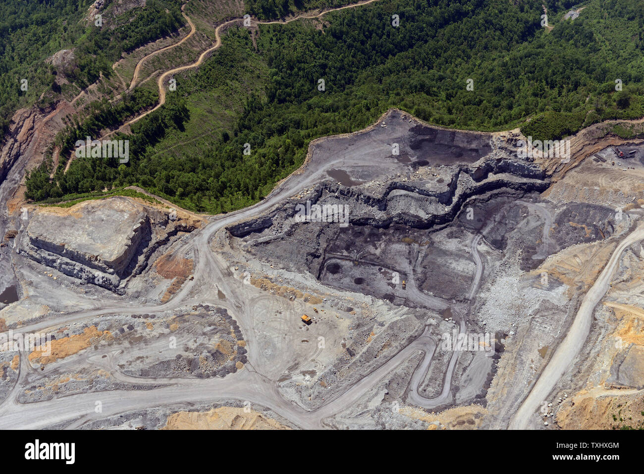 An aerial photo shows a mountaintop removal site and sludge pond in ...
