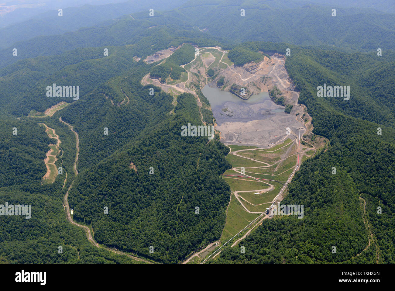 An aerial photo shows a mountaintop removal site and sludge pond in ...