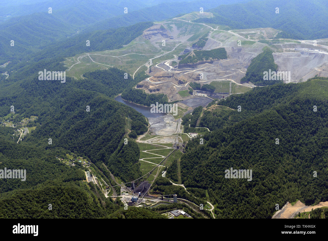 An aerial photo shows a mountaintop removal site and sludge pond in ...
