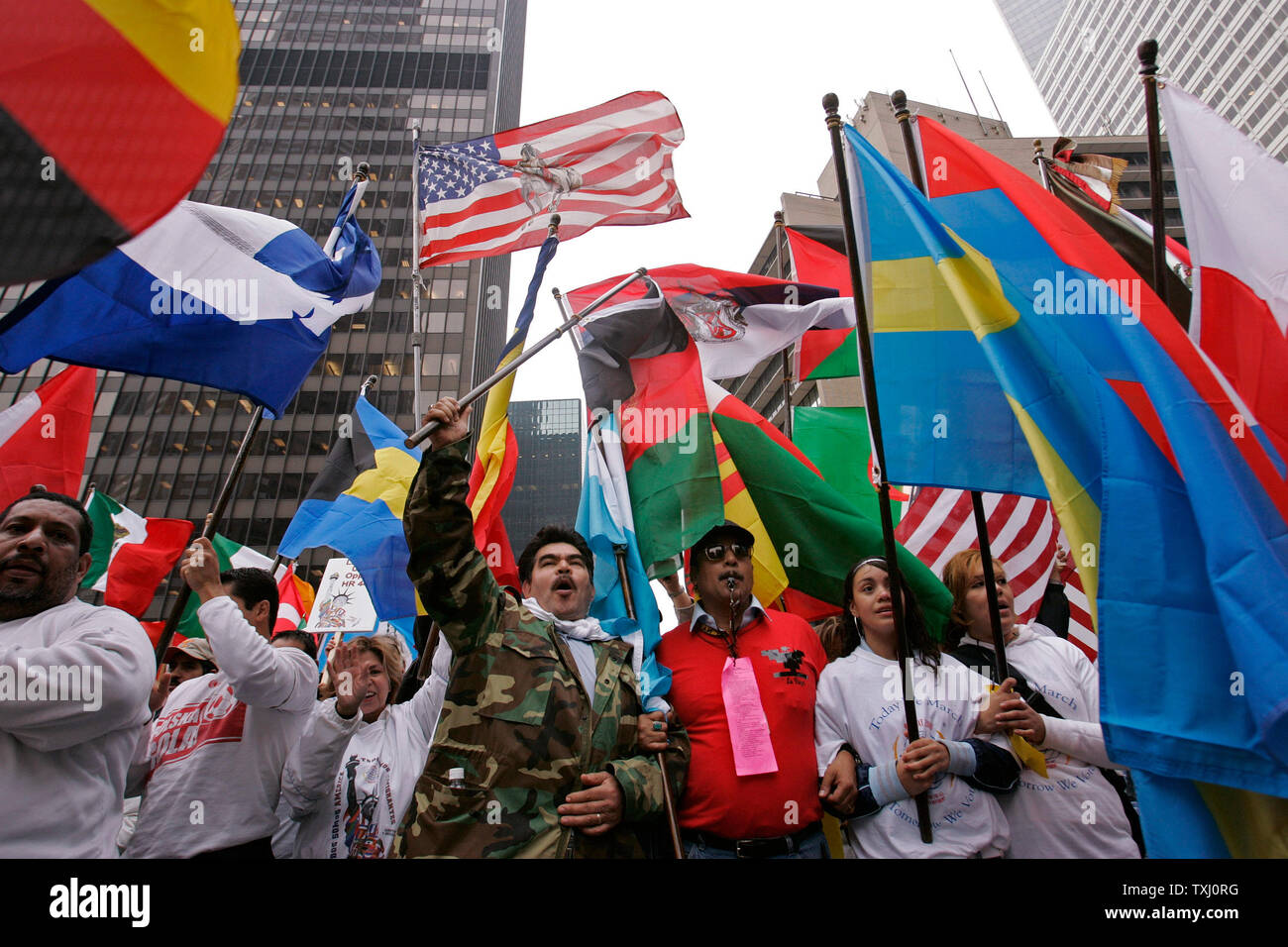 Demonstrators carrying flags of different nations march through ...